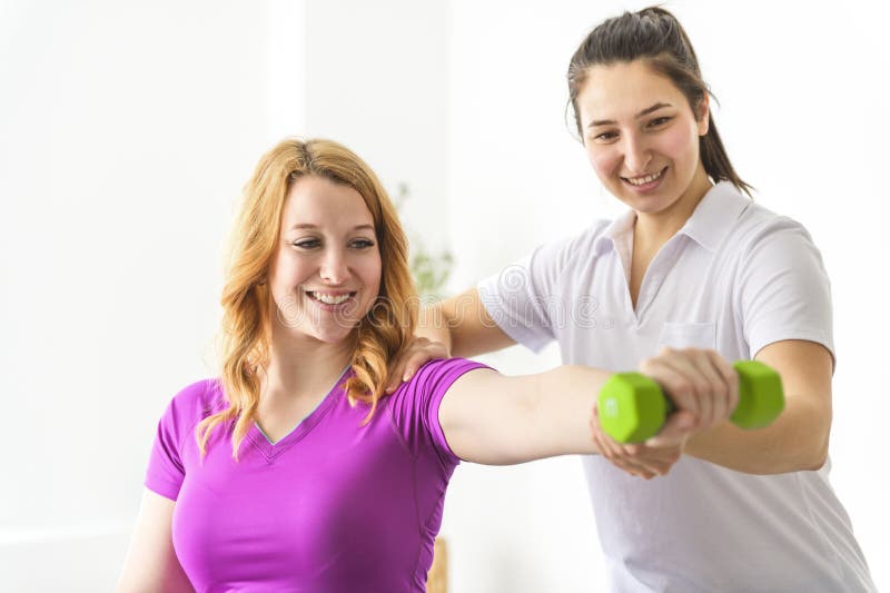 Modern Rehabilitation Physiotherapy at Work with Client Holding ...