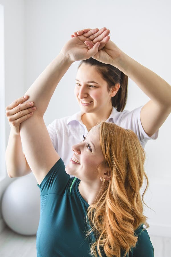 Modern Rehabilitation Physiotherapy Woman Worker with Woman Client ...