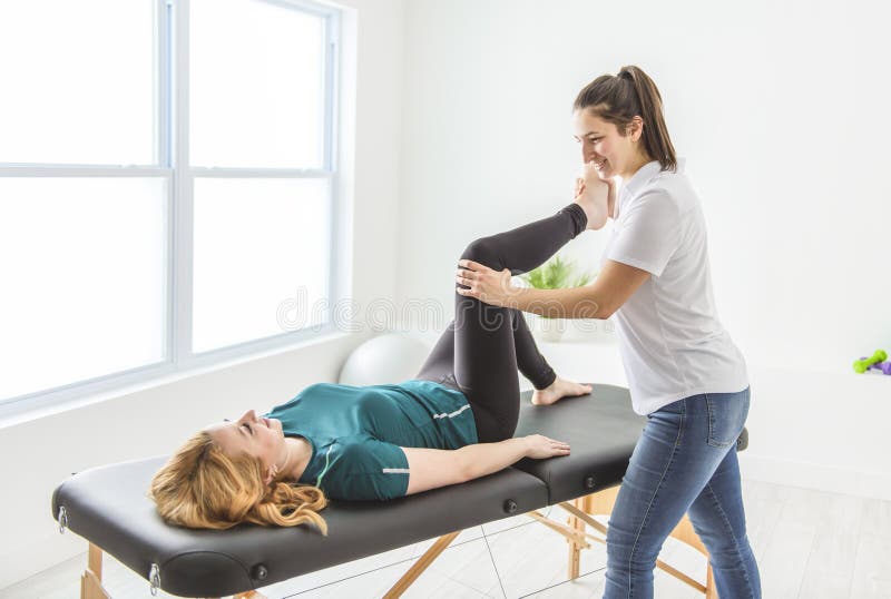 Modern Rehabilitation Physiotherapy Woman Worker with Woman Client ...
