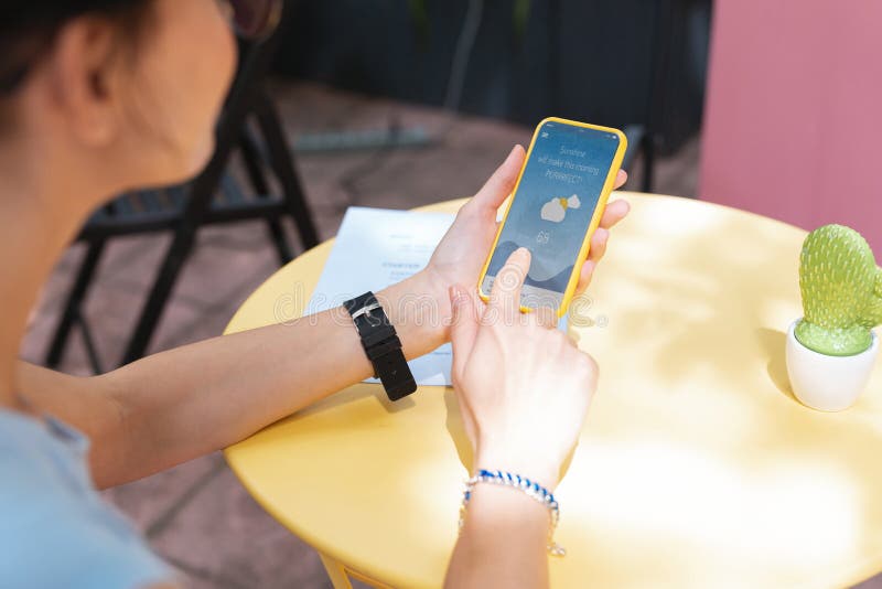 Modern Remote Worker Checking Weather Forecast on Her Phone Stock Photo ...