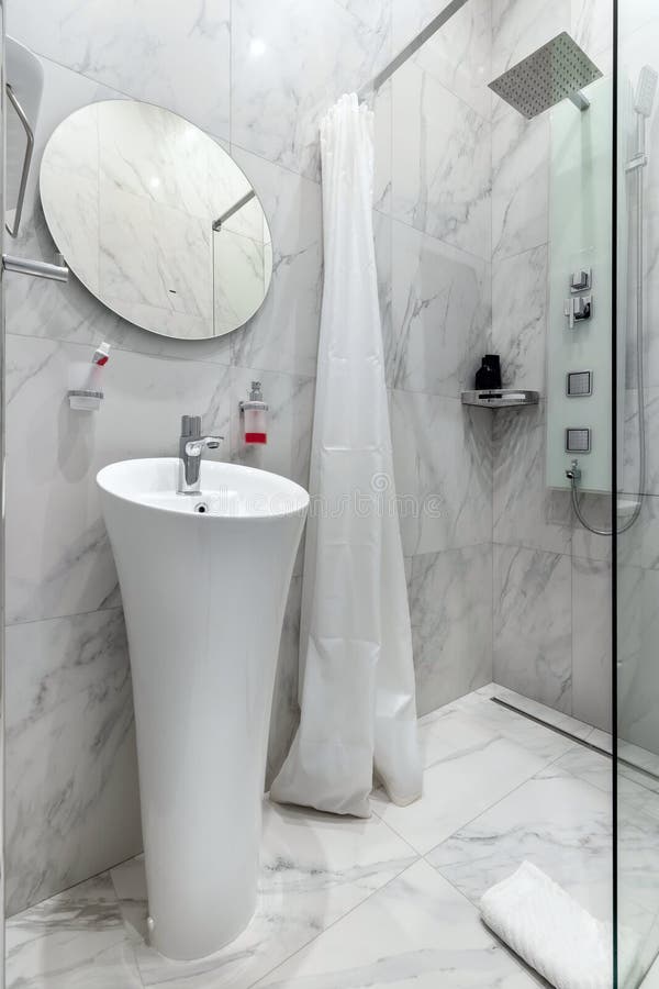 Modern Renovated Bathroom with a White Shell, Mirror and Marble Wall ...