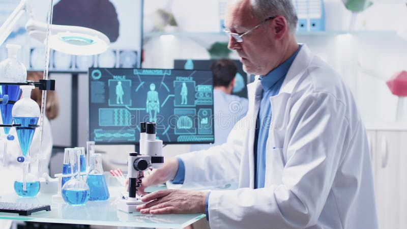In Modern Research Facility Mature Chemist is Taking Notes Stock Video ...