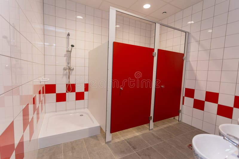 This is a Modern Restroom Equipped with Red Accents and Convenient ...