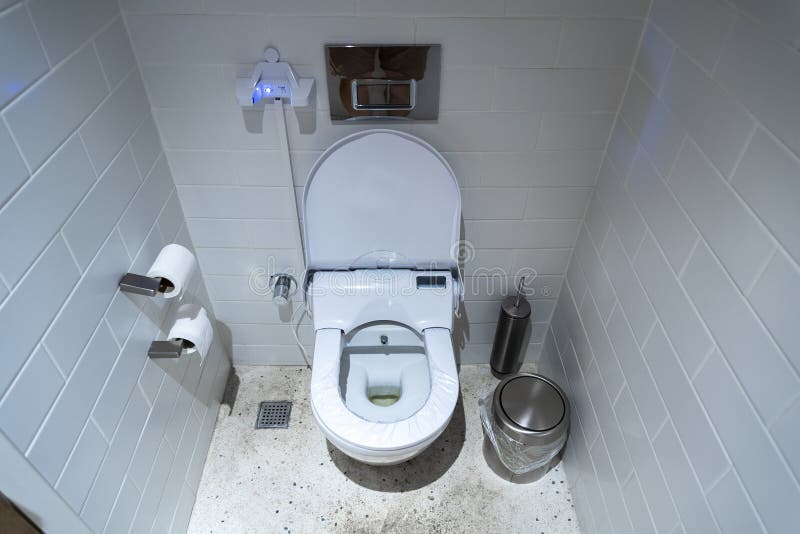 Modern Restroom Featuring a High-tech Toilet and Minimalist Design ...