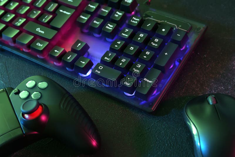 Modern RGB Keyboard, Mouse and Video Game Controller on Grey Table ...