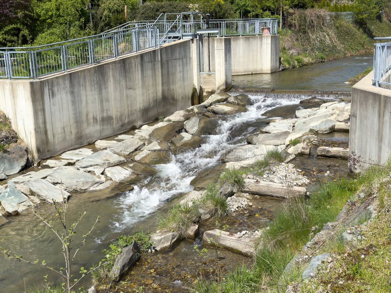 Modern River Dam Structure with Flowing Water and Concrete Barriers in ...