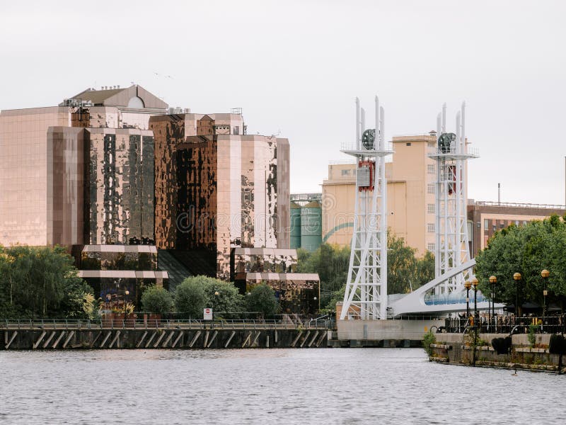 Modern Riverside Architecture with Reflective Buildings and Bridge ...