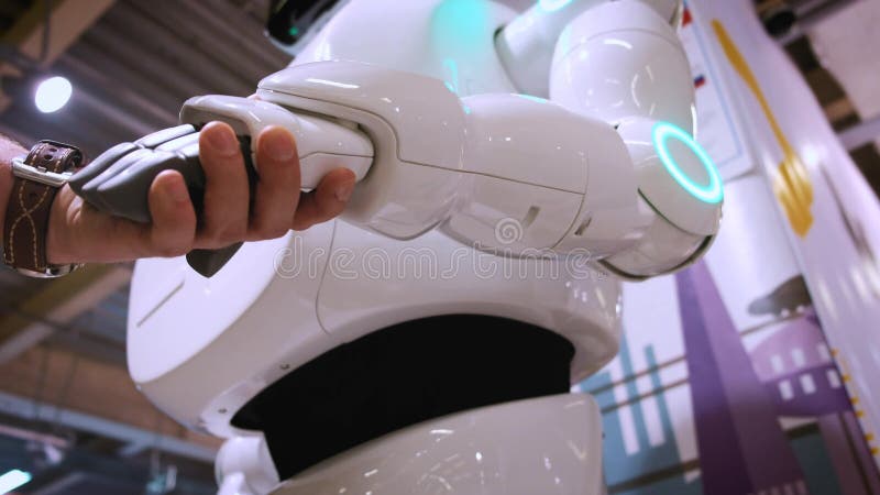 Modern Robotic Technologies. a Man Communicates with a Robot, Presses a ...