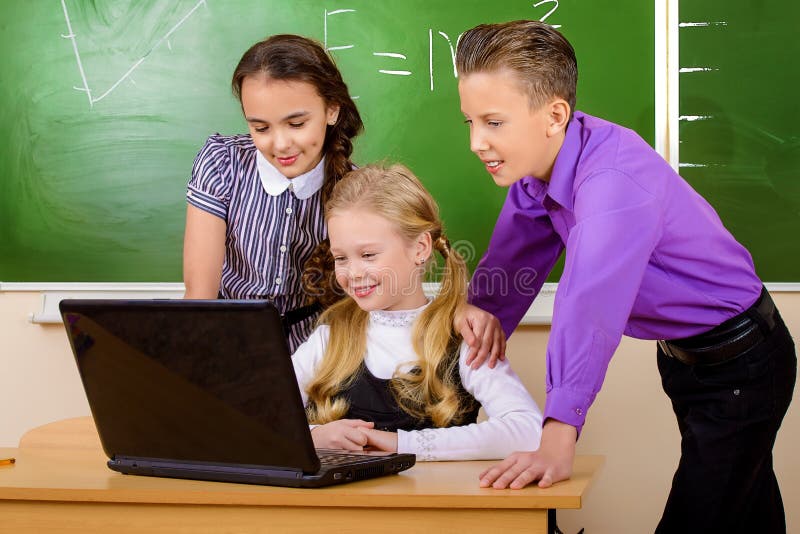 Teacher Using Computer with Students in Classroom Stock Photo - Image ...