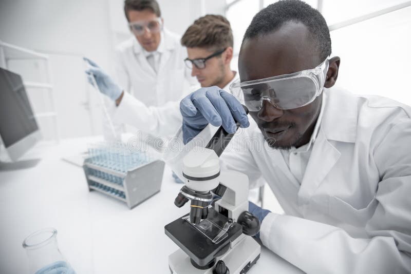 Modern Scientist Uses a Microscope in a Laboratory Stock Photo - Image ... Modern Scientist Uses a Microscope in a Laboratory Stock Photo - Image ...
