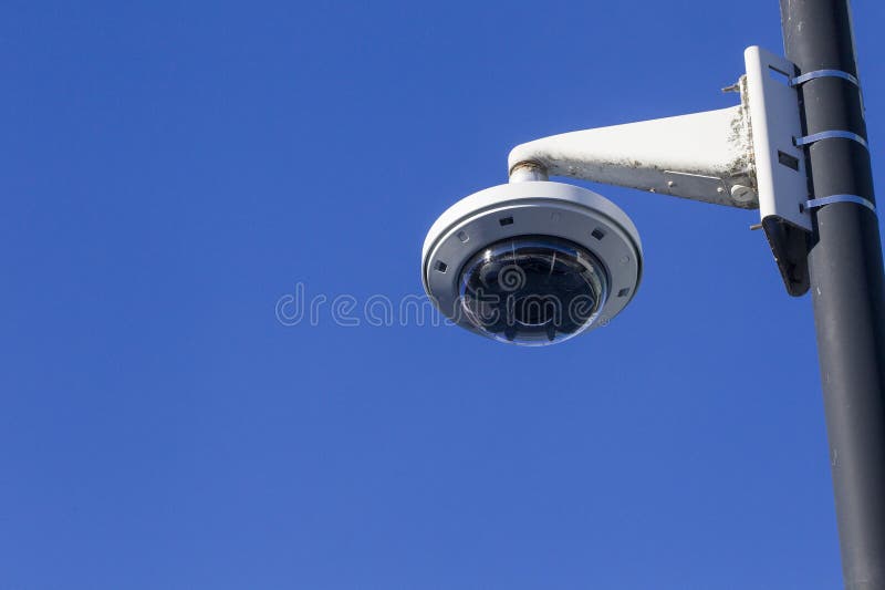Modern Security Camera Mounted on a Pole Against a Clear Blue Sky Stock ...