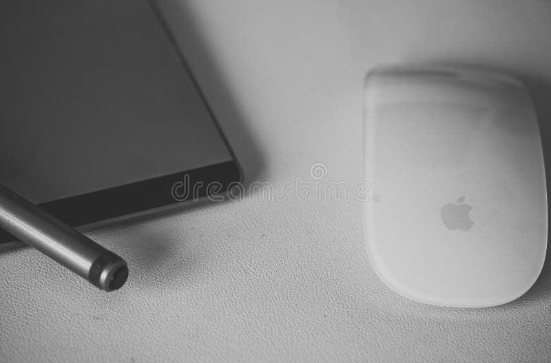 A Computer Mouse is Sitting Next To a Cellphone and Tablet Editorial ...