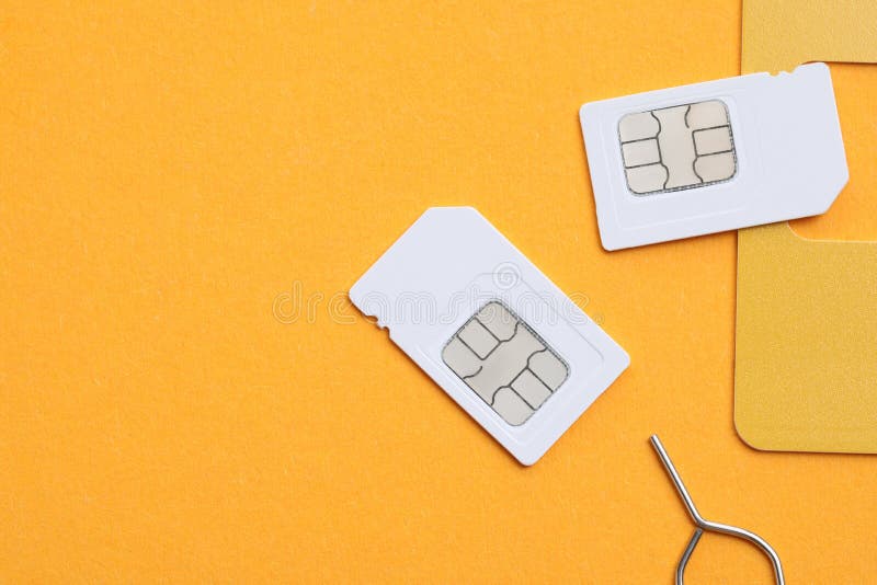 Modern SIM Cards and Needle on Orange Background, Flat Lay. Space for ...