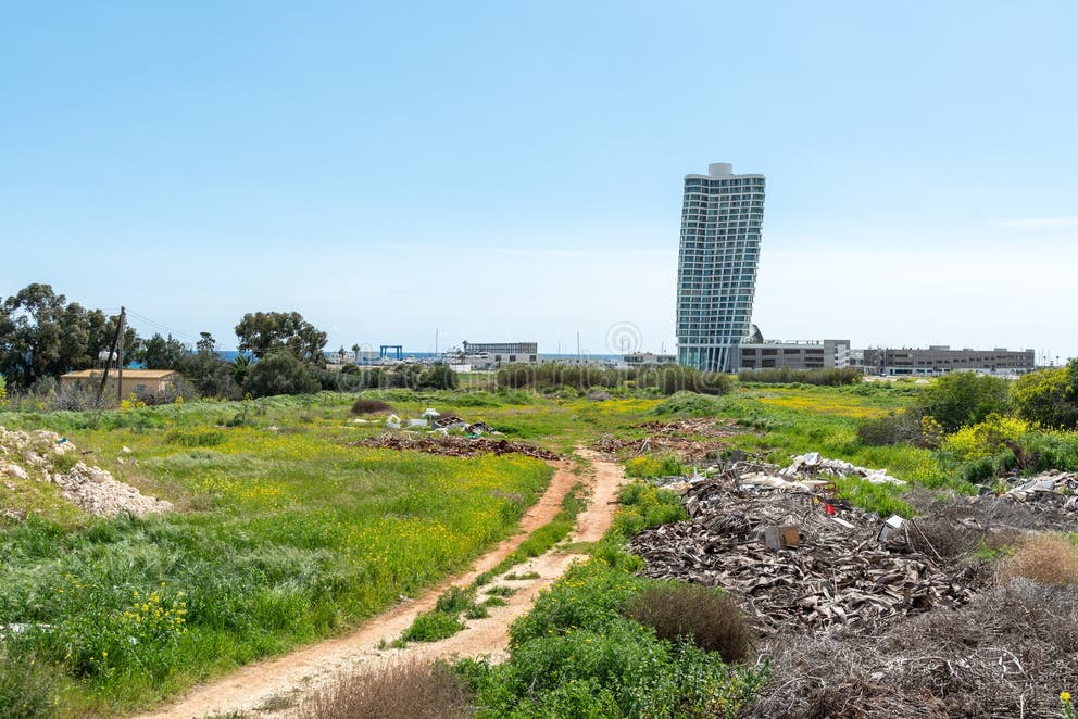 Modern Skyscraper and Junk Yard of Construction Debris Outside in the ...