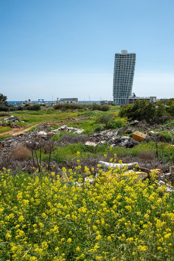 Modern Skyscraper and Junk Yard of Construction Debris Outside in the ...