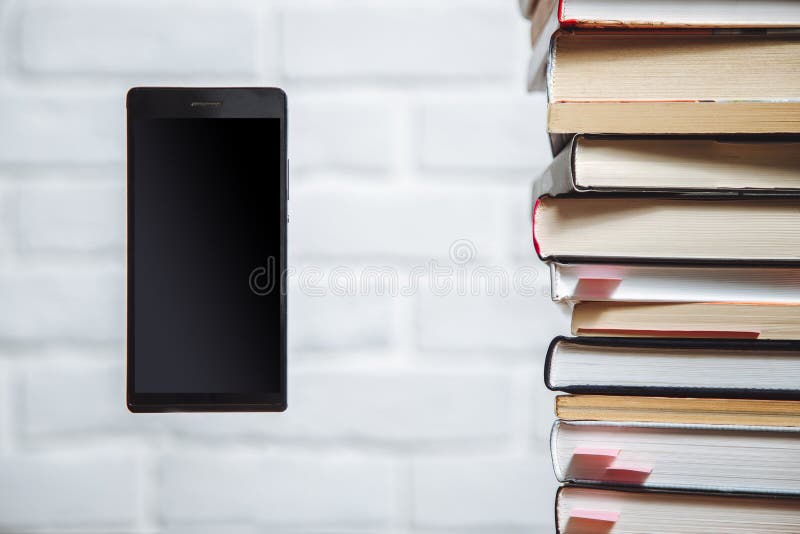 Modern Smartphone with Blank Screen and Pile of Books on a Desk ...