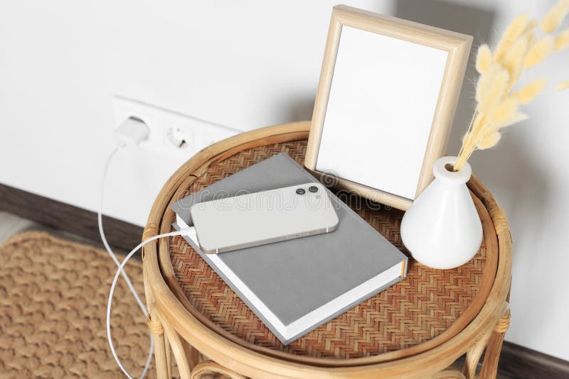 Modern Smartphone Charging on Round Rattan Table Indoors Stock Image ...