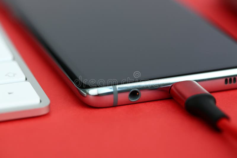 Modern Smartphone Connected To Usb Data Cable Toned in Coral Colour ...