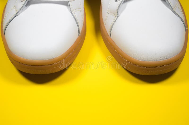 Modern Sneakers on the Yellow Background. White Leather Trainers on ...