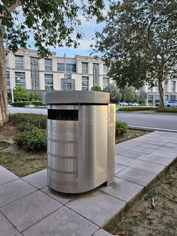 Modern Stainless Steel Trash Bin on a Sidewalk in Urban Area Stock ...