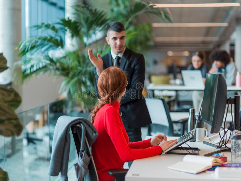 In a Modern Startup Office, a Diverse Group of Young Professionals ...