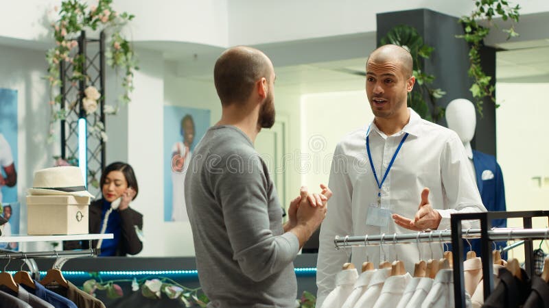 Modern Stylish Store Employee Helping a Client Explore Clothing Options ...