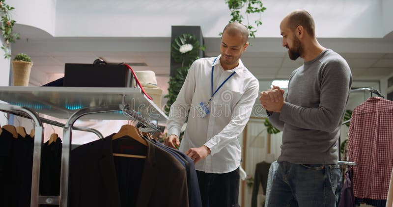 Modern Stylish Store Employee Helping a Client Explore Clothing Options ...
