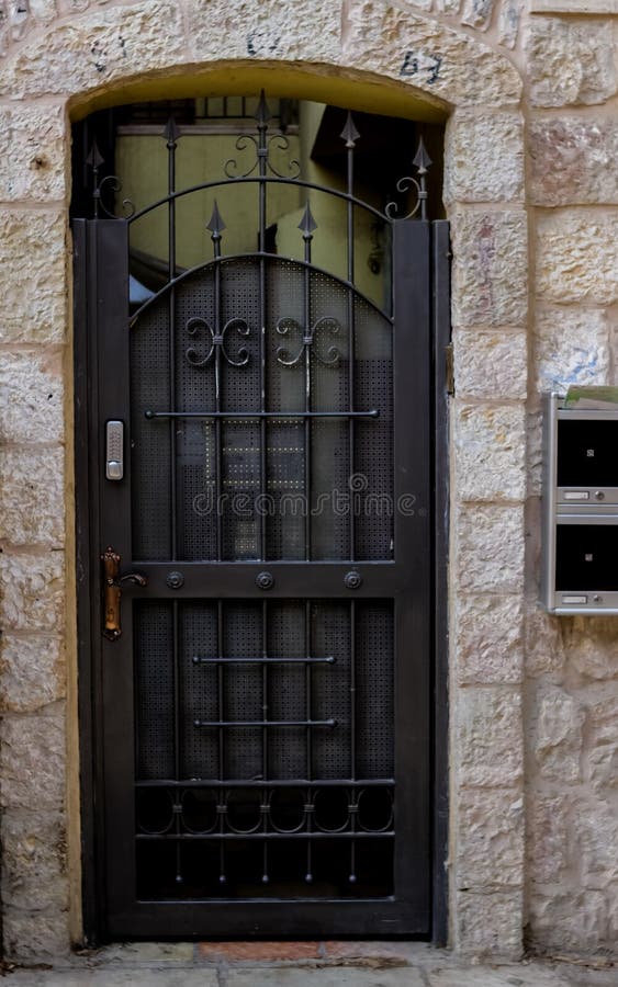 Modern Stylized Metal Gate with Grating and Peaks Stock Photo - Image ...