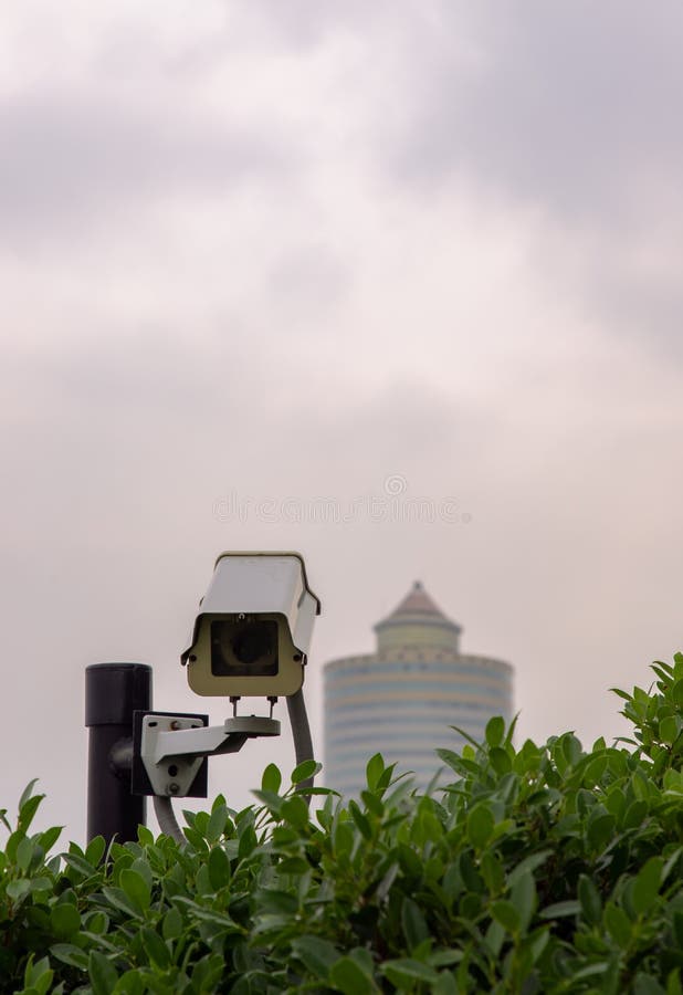 Modern Surveillance Cameras in the Park with Tall Building Background ...