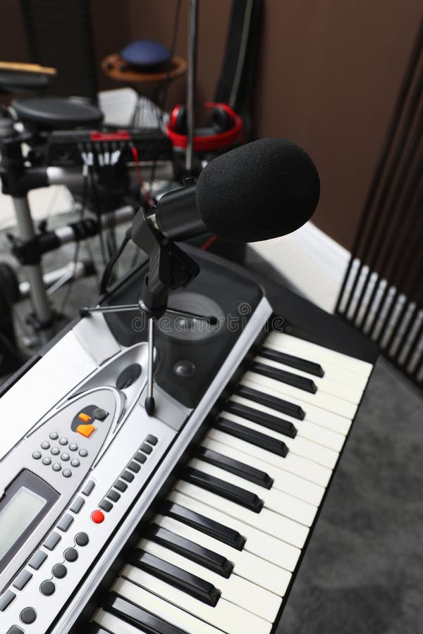 Modern Synthesizer with Microphone at Recording Studio. Music Band ...