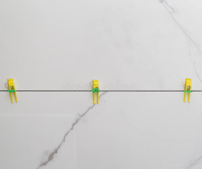 Modern System for Leveling Tiles during Installation. Installation of ...