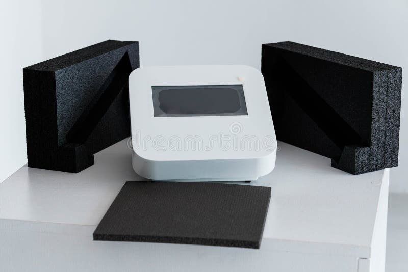 Modern Tech Device with Protective Black Foam Packaging on White Table ...