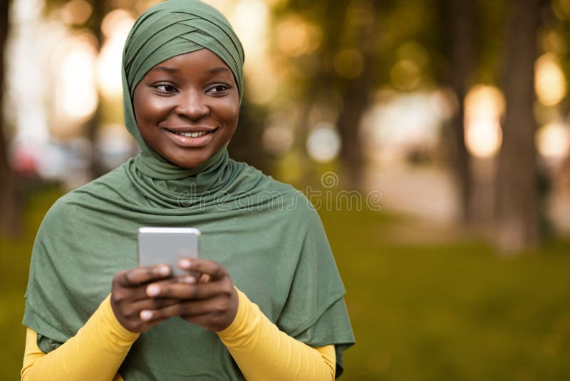 Modern Technologies and Islam. Smiling Black Muslim Woman Using ...