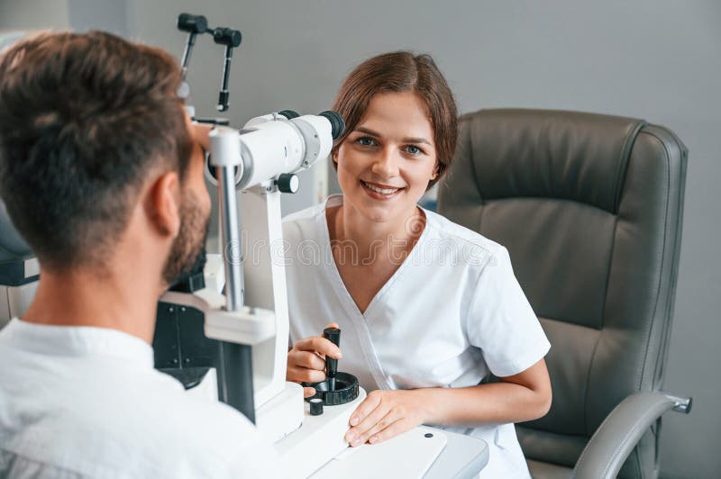 Modern Technologies. Man`s Vision Checked by Female Doctor in the ...