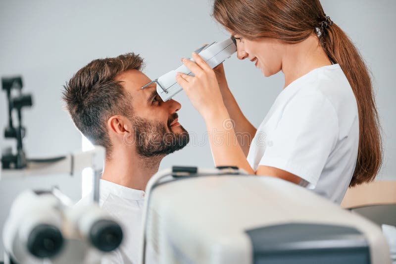 Modern Technologies. Man`s Vision Checked by Female Doctor in the ...