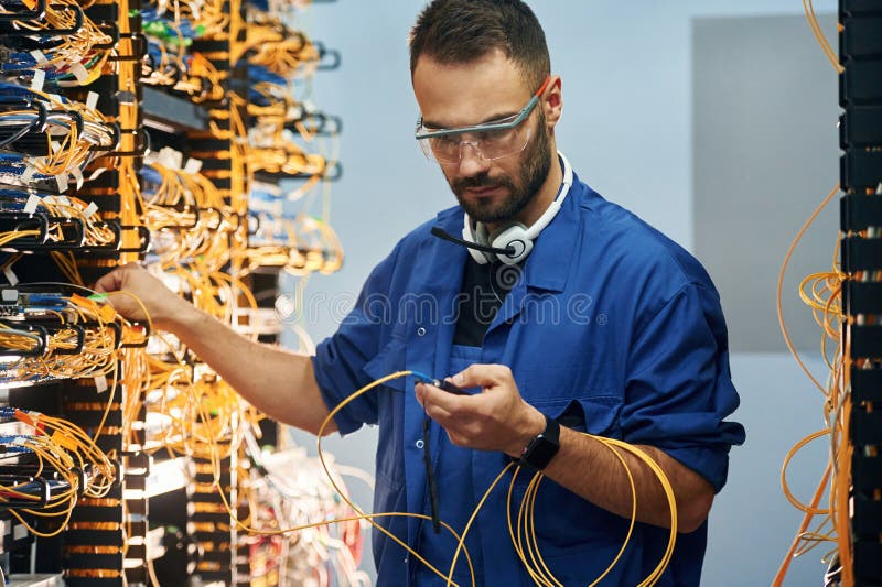 Modern Technology Routing. Young Man is Working with Internet Equipment ...