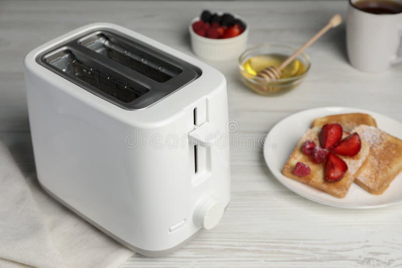 Modern Toaster and Bread with Fresh Berries on White Wooden Table Stock ...