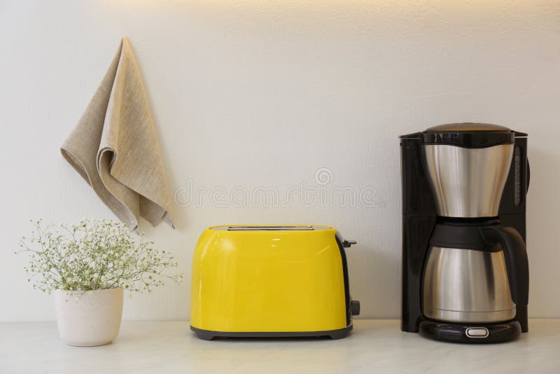 Modern Toaster, Coffee Machine and Flowers on Counter in Kitchen Stock ...