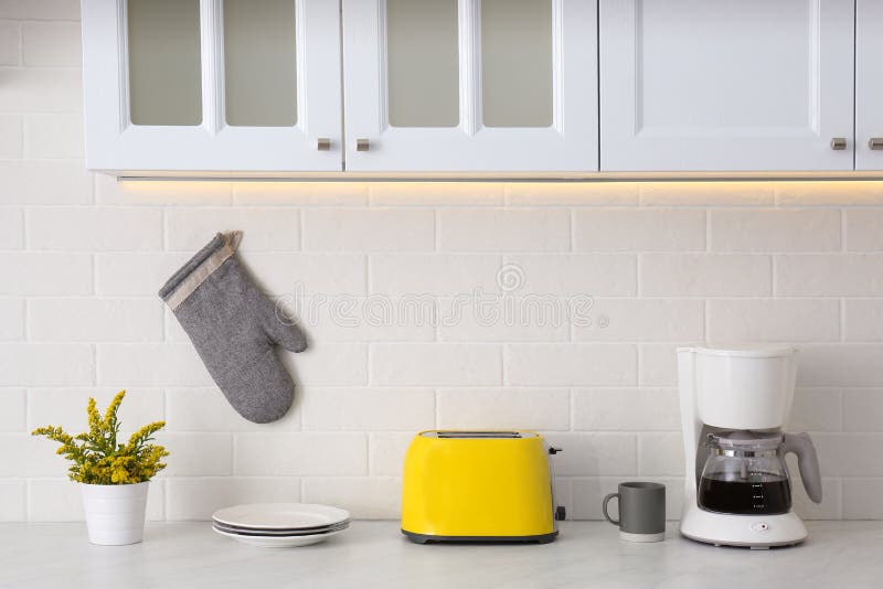 Modern Toaster, Coffeemaker and Dishware on Counter Stock Image - Image ...