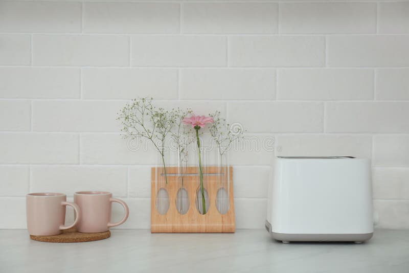 Modern Toaster, Cups and Flowers on Counter in Kitchen Stock Image ...