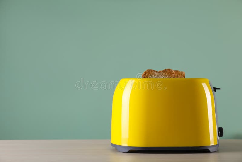 Modern Toaster with Slices of Roasted Bread on Wooden Table. Space for ...