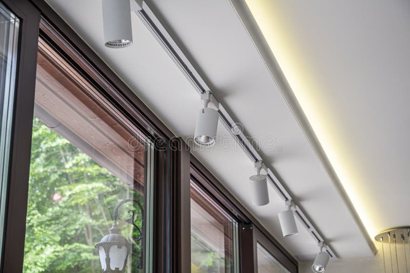 A Modern Track Lighting System with Adjustable White Spotlights is ...