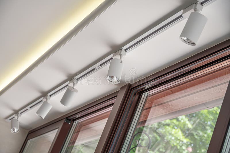 A Modern Track Lighting System with Adjustable White Spotlights is ...