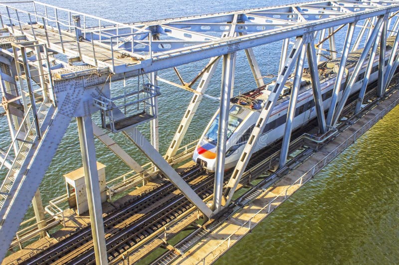 Modern Train Hurtling Across the Bridge Over the River Stock Photo ...