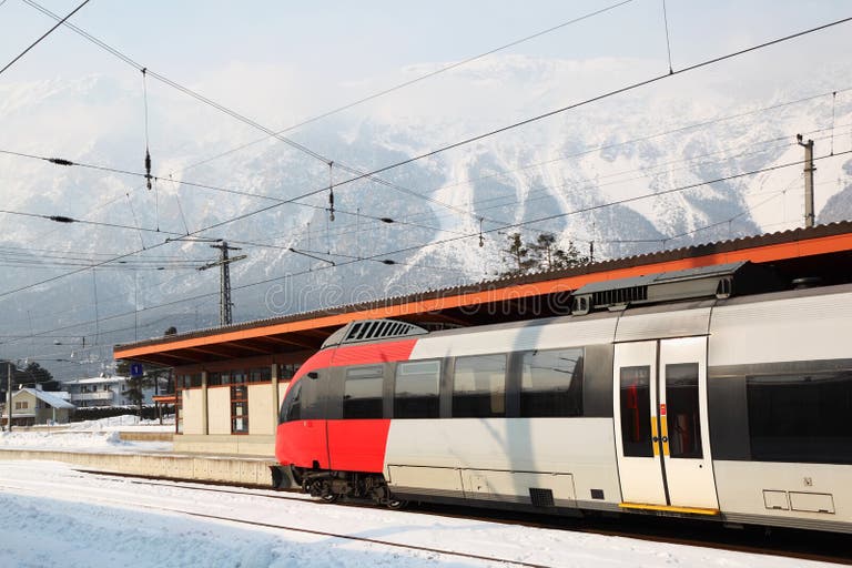 Modern Train Stops at Station Near Mountains Stock Image - Image of ...