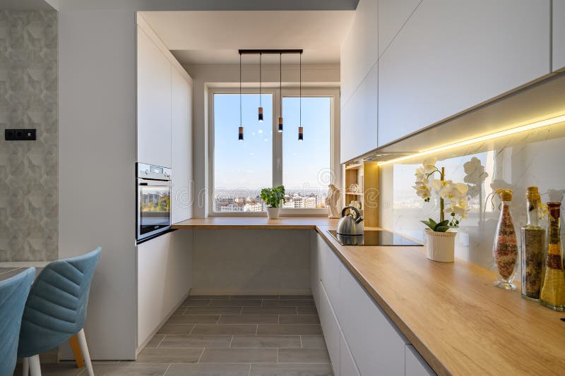 A Trendy White Studio with a State-of-the-art Kitchen Stock Image ...