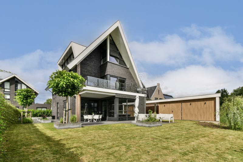 Modern Triangular House with Garden Stock Photo - Image of property ...