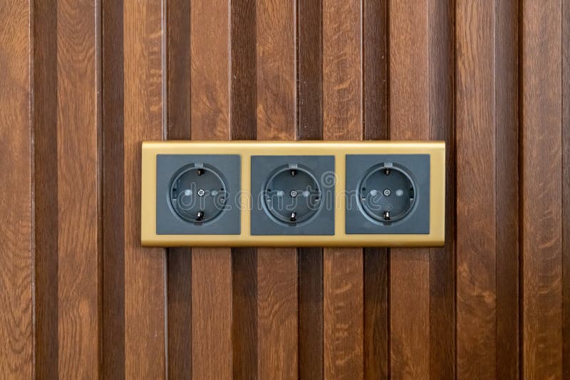 Modern Triple Socket Mounted on Wood Veneer Wall Stock Image - Image of ...