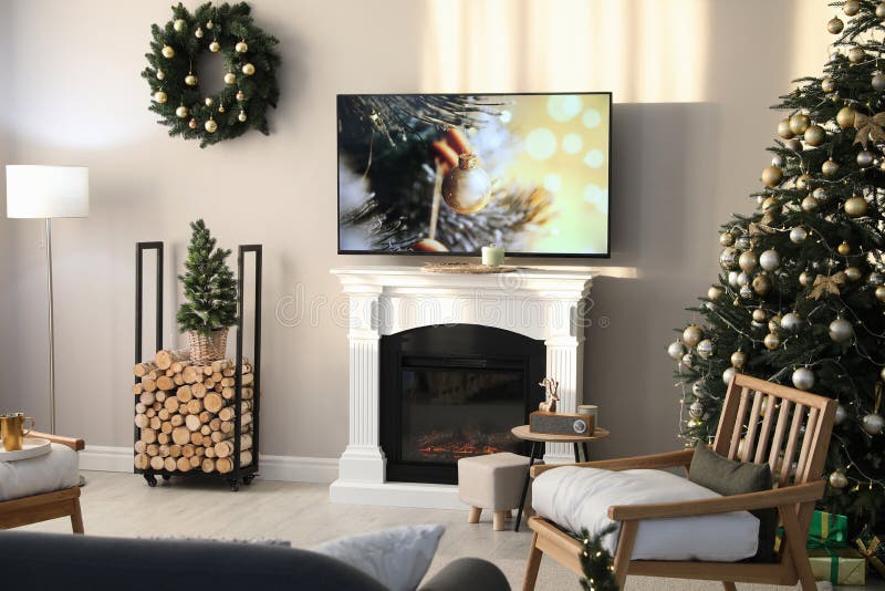 Modern TV Set on Light Wall in Room Decorated for Christmas Stock Photo ...
