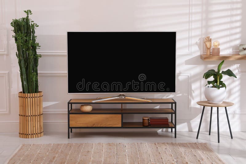 Modern TV on Stand Near White Wall Indoors. Interior Design Stock Photo ...